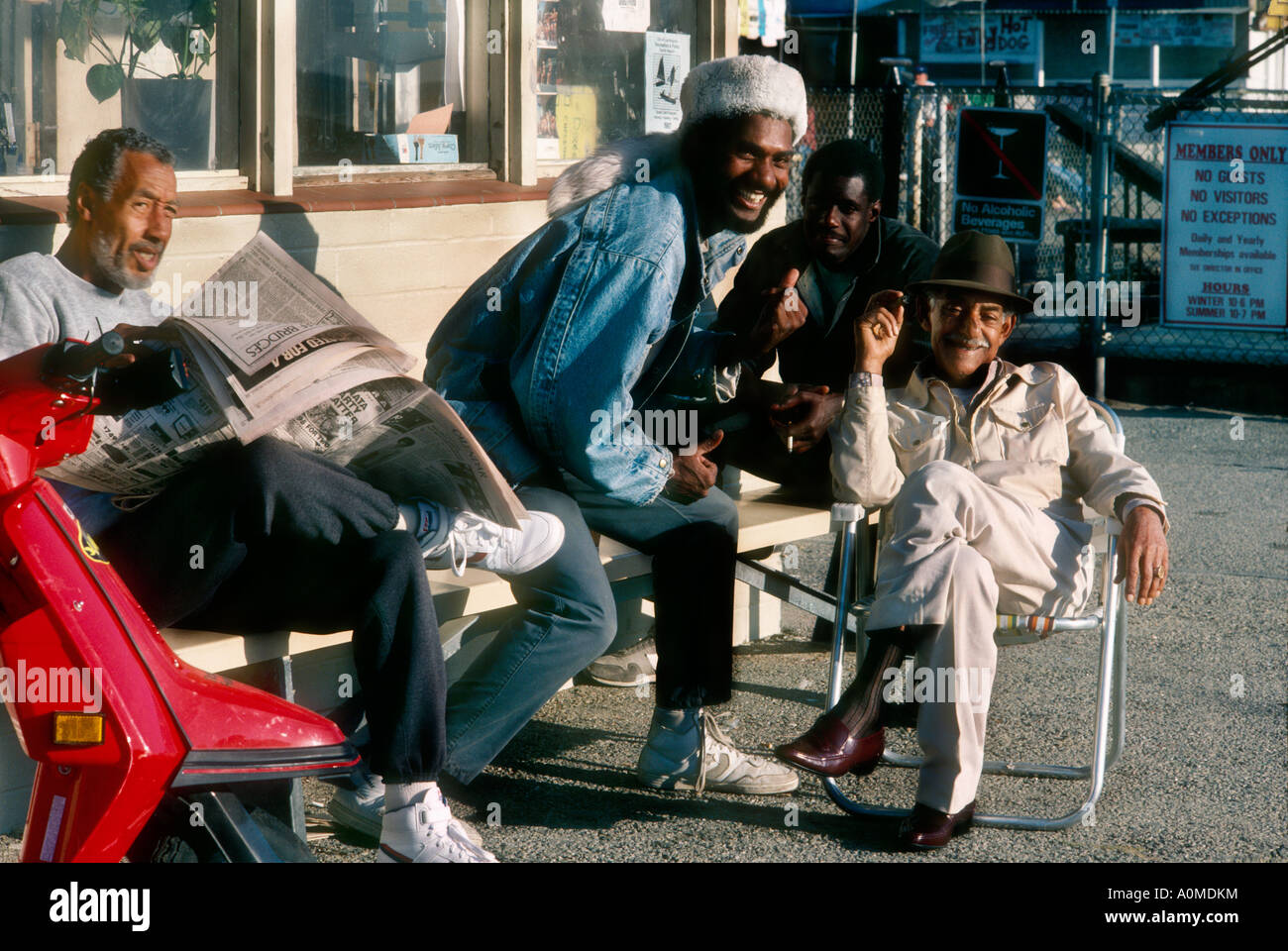 Group of men socialising "hanging out" late afternoon on Venice Beach ...