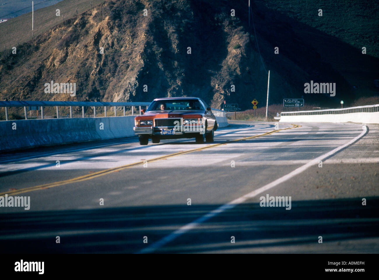American classic car driving along Highway One, Northern California ...