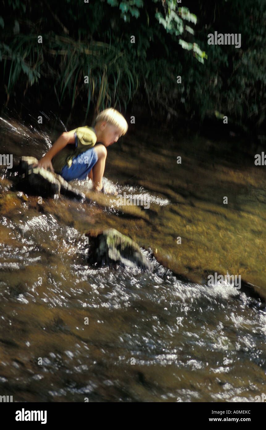 1 one young boy 5 6 7 8 years old playing in stream wet water fun ...