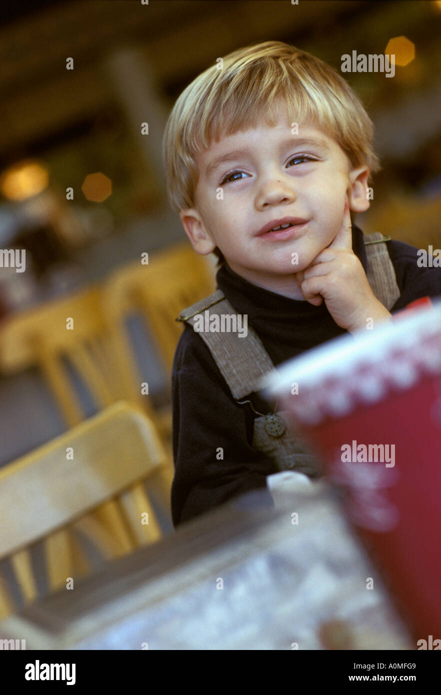 1 one young male boy finger along side of face stare staring look ...