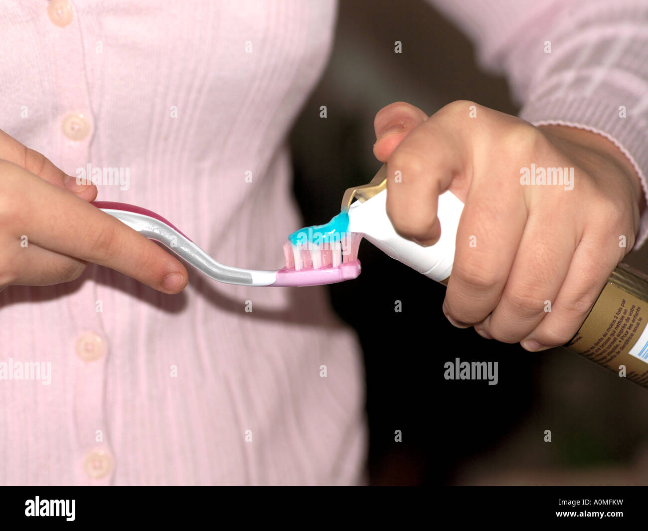 Teenager Putting Toothpaste on Toothbrush Stock Photo - Alamy