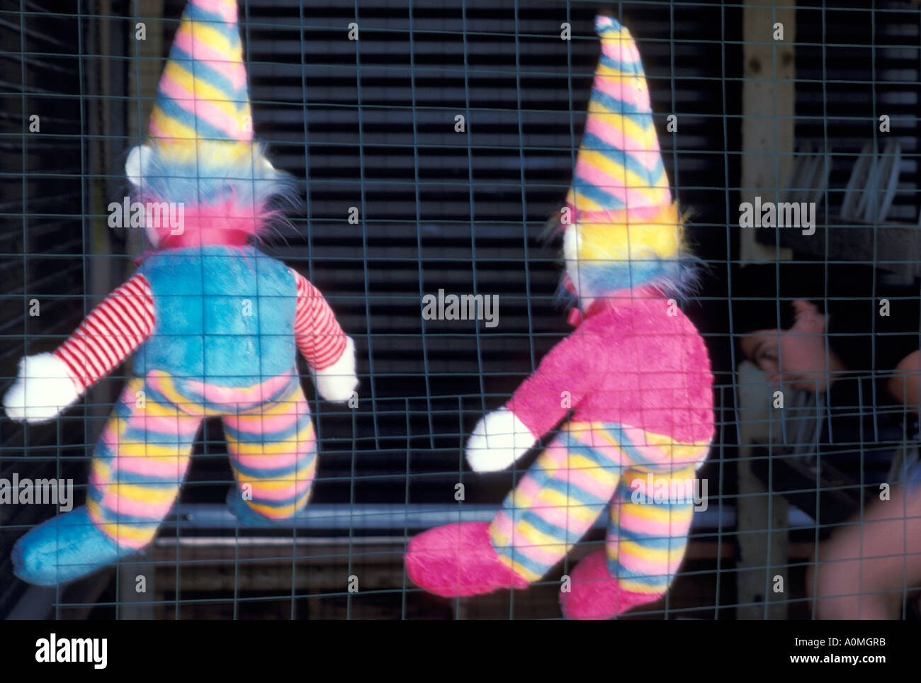 2 two stuffed clowns color colorful colourful stripes striped hanging ...