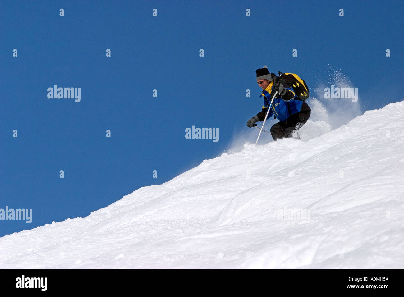 man enjoying the powder snow through on a winter day in grand bornand ...