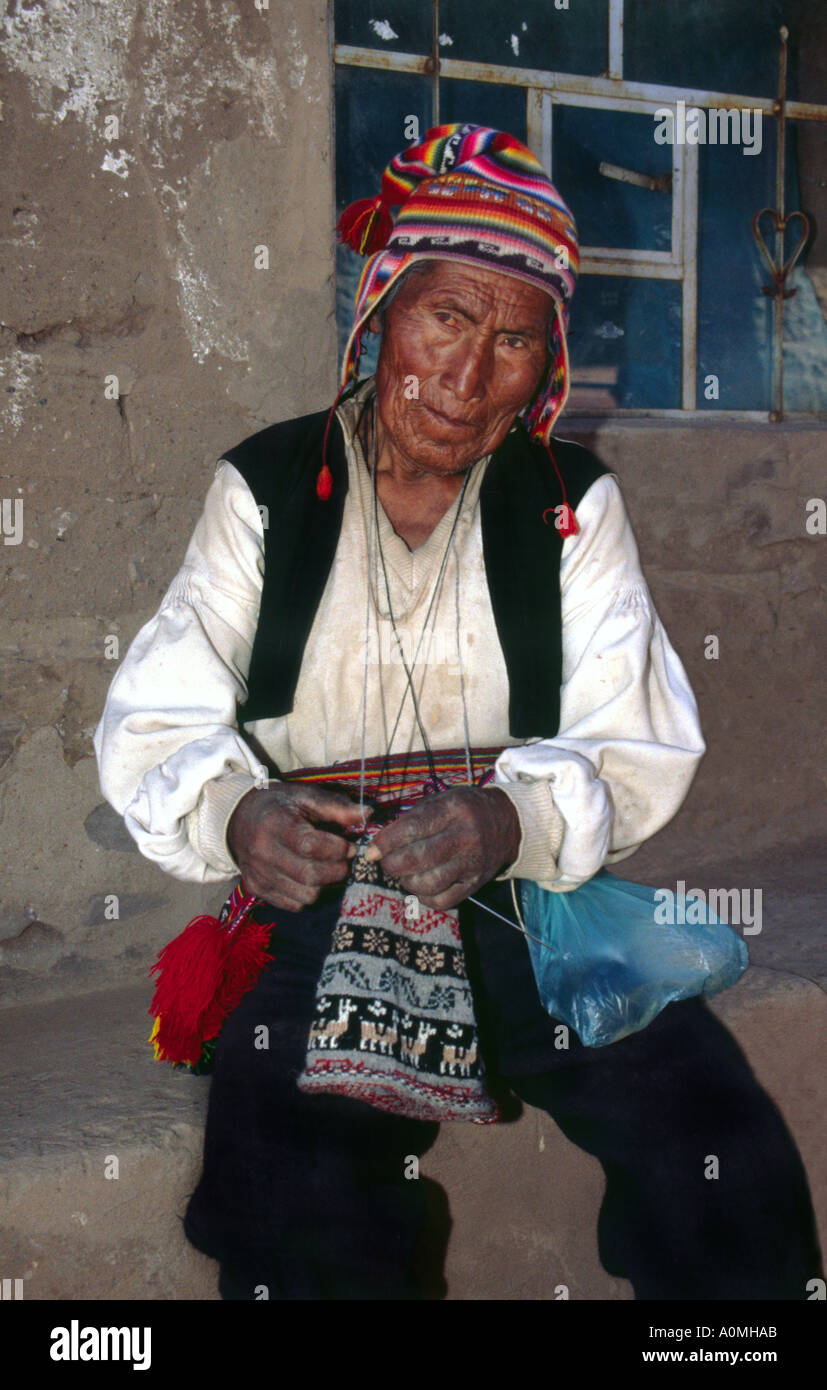 Man knitting traditional woollen hats worn by the men on Taquile island ...