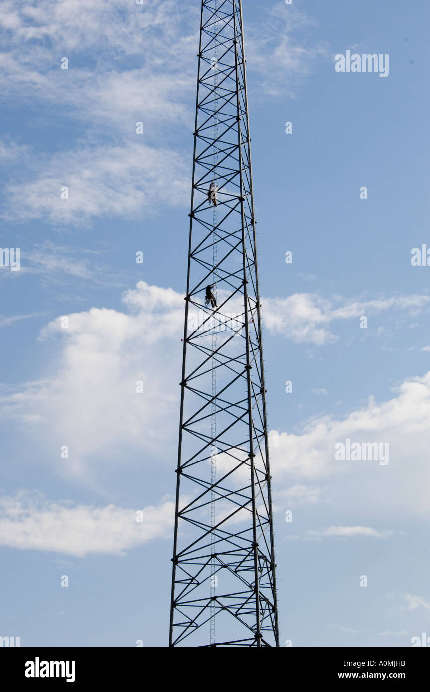 Telecommunications Workers Climbing Tower Stock Photo - Alamy