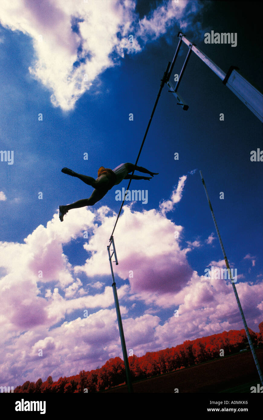 pole vaulter leaps toward sky Stock Photo - Alamy