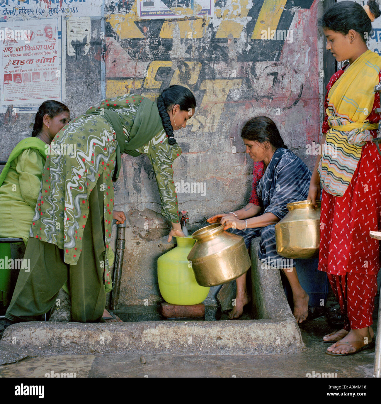 RVA92591 Women in slum collecting water from community tap Stock Photo ...