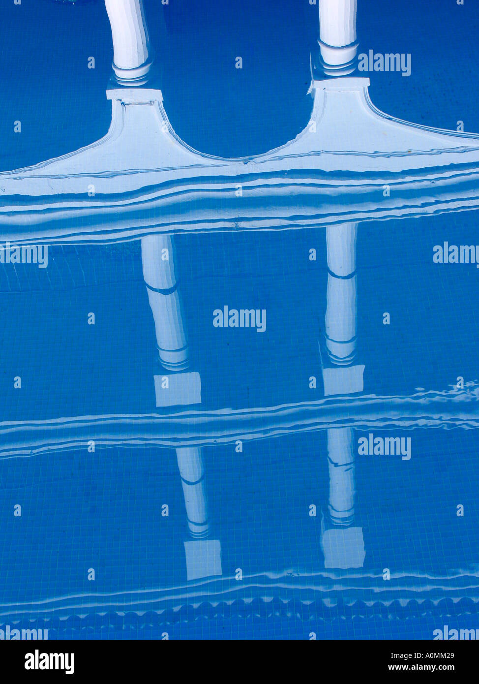 Columns reflected in swimming pool Stock Photo - Alamy