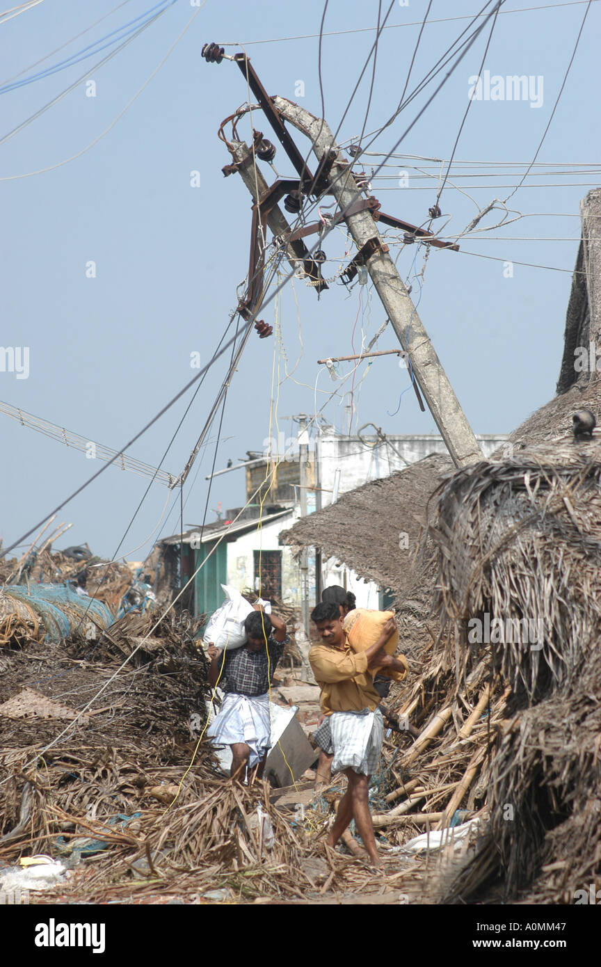 people running with food bags below broken lamp post after Tsunami ...