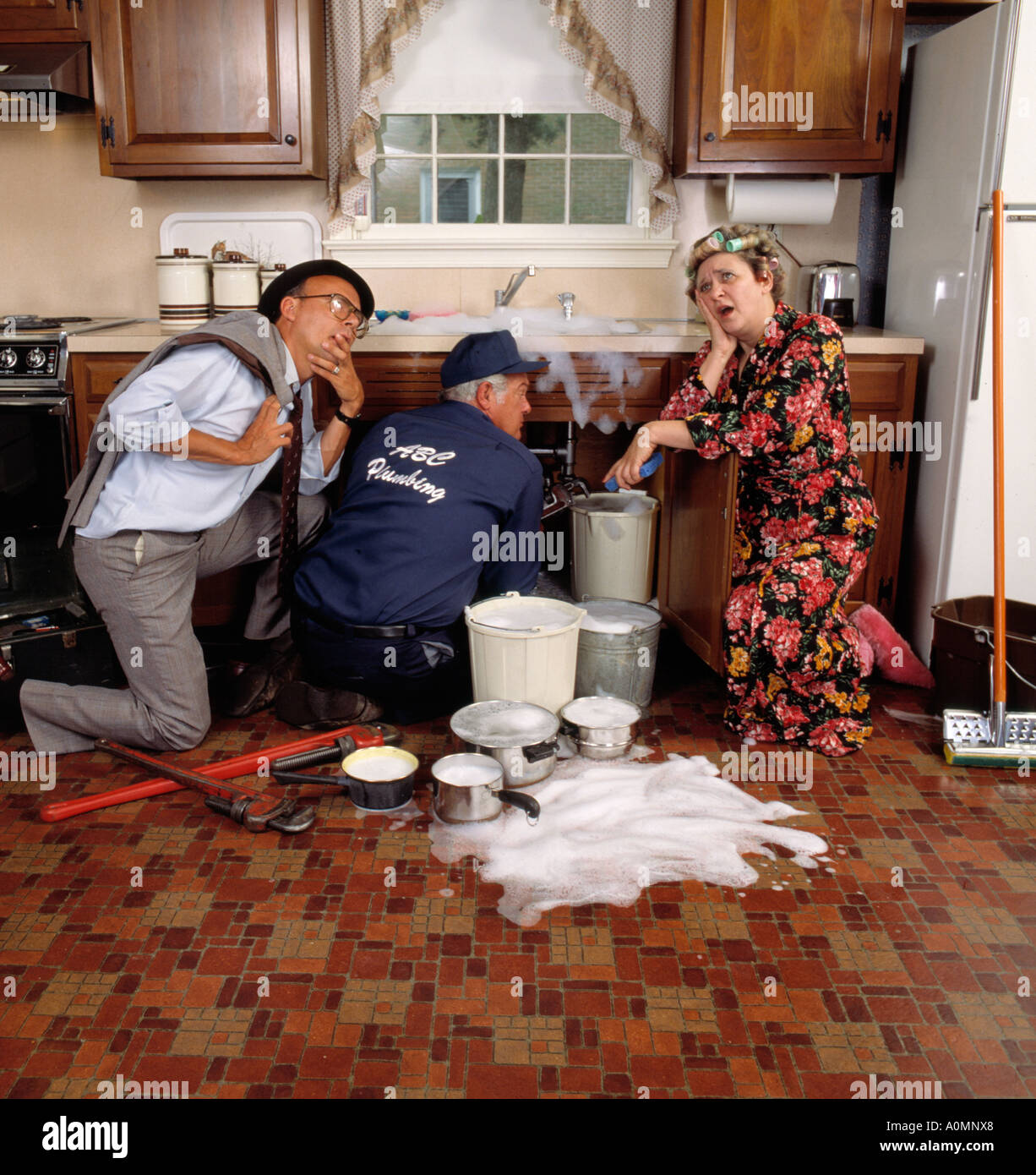 kitchen sink plumbing disaster housewife plumber husband Stock Photo ...