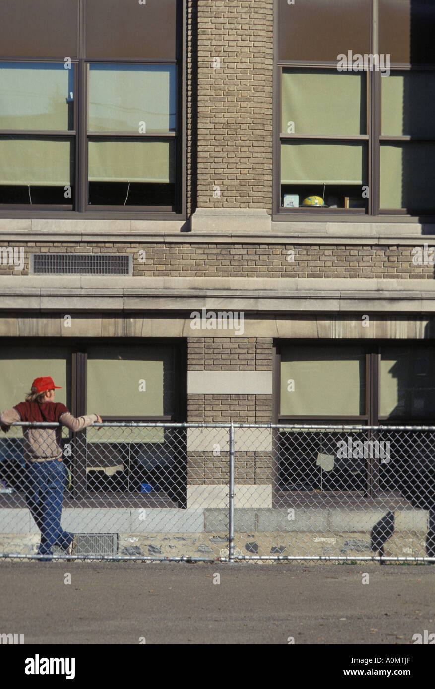 school yard chain link fence loiter wait waiting teen teenager Stock ...