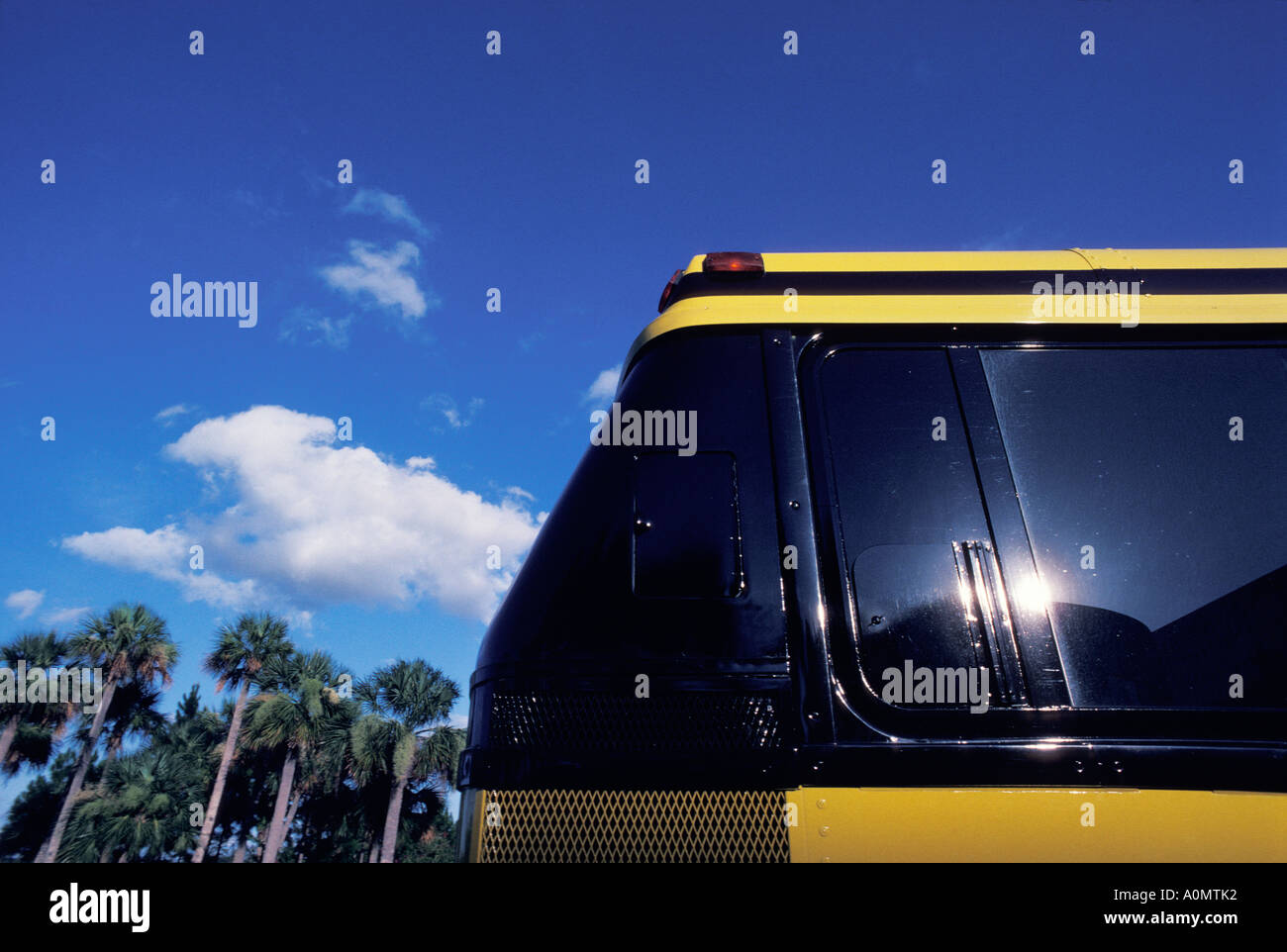 yellow school bus blue sky white clouds Stock Photo - Alamy