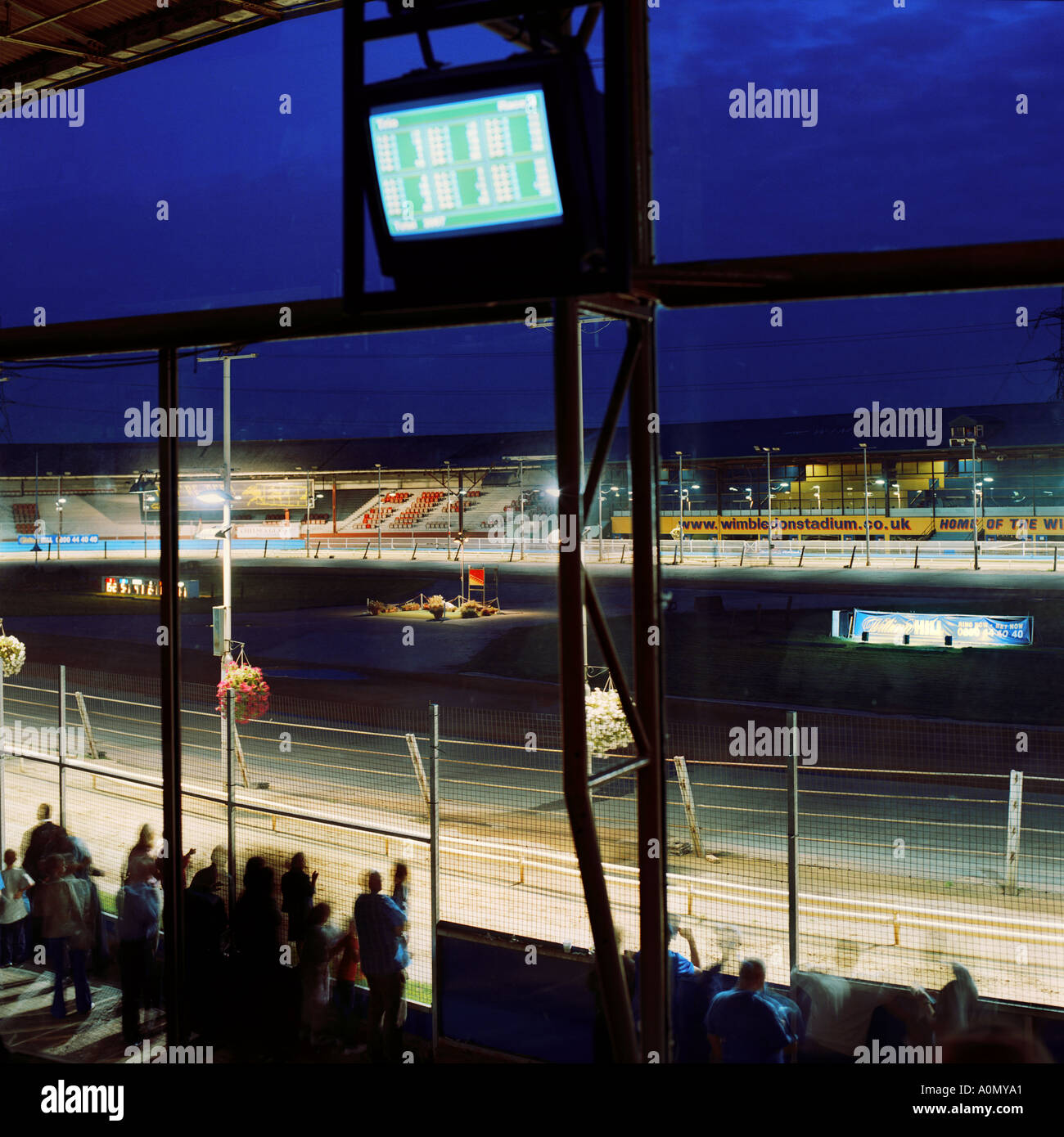 Night interior shot of Wimbledon Greyhound Stadium racing track, south ...
