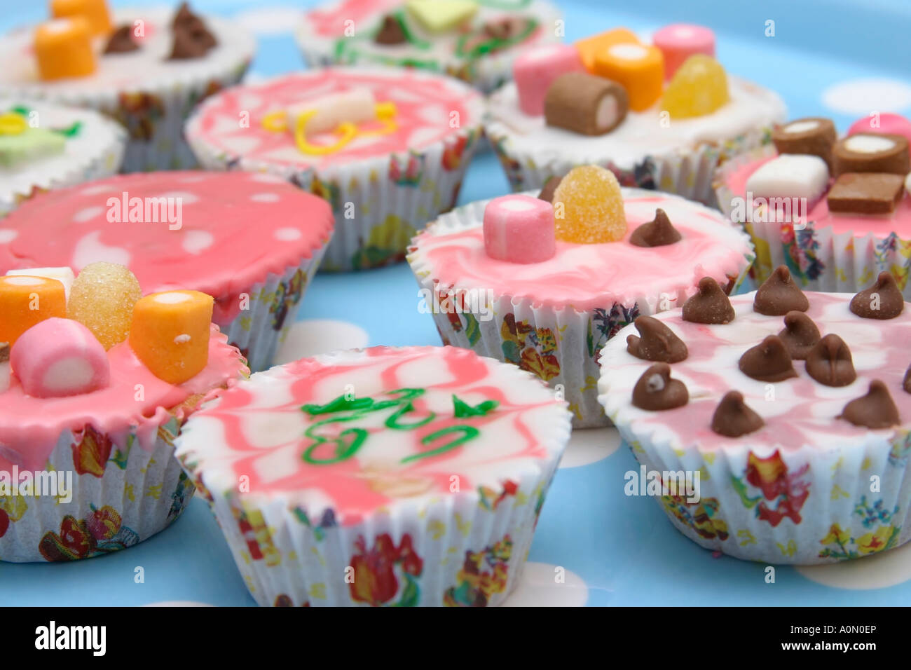 party cup cakes covered in icing sugar sweets and chocolate Stock Photo ...