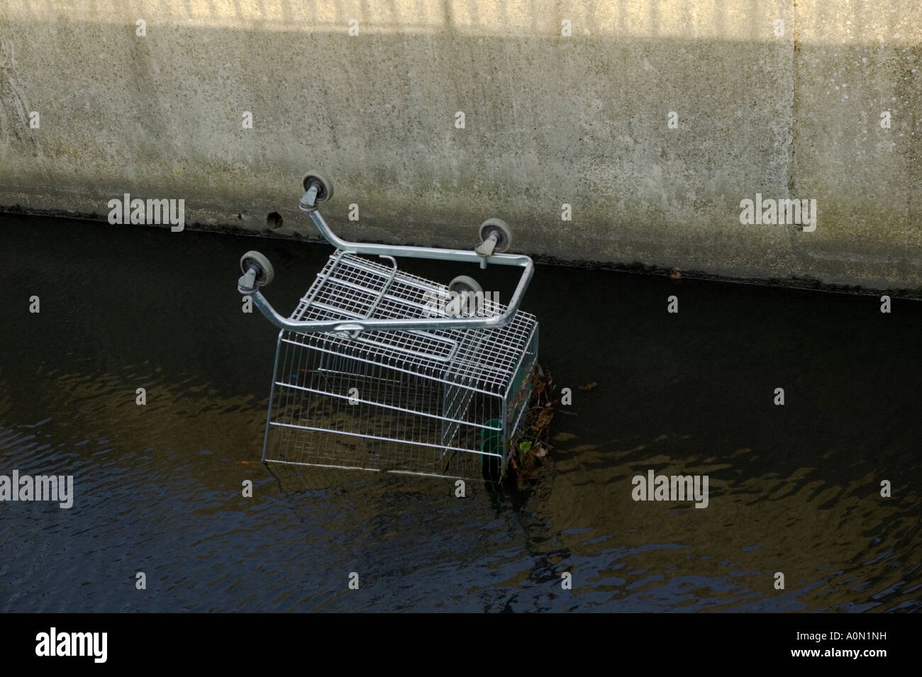 Inverted shopping trolley in the River Ravensbourne, Bromley, London ...