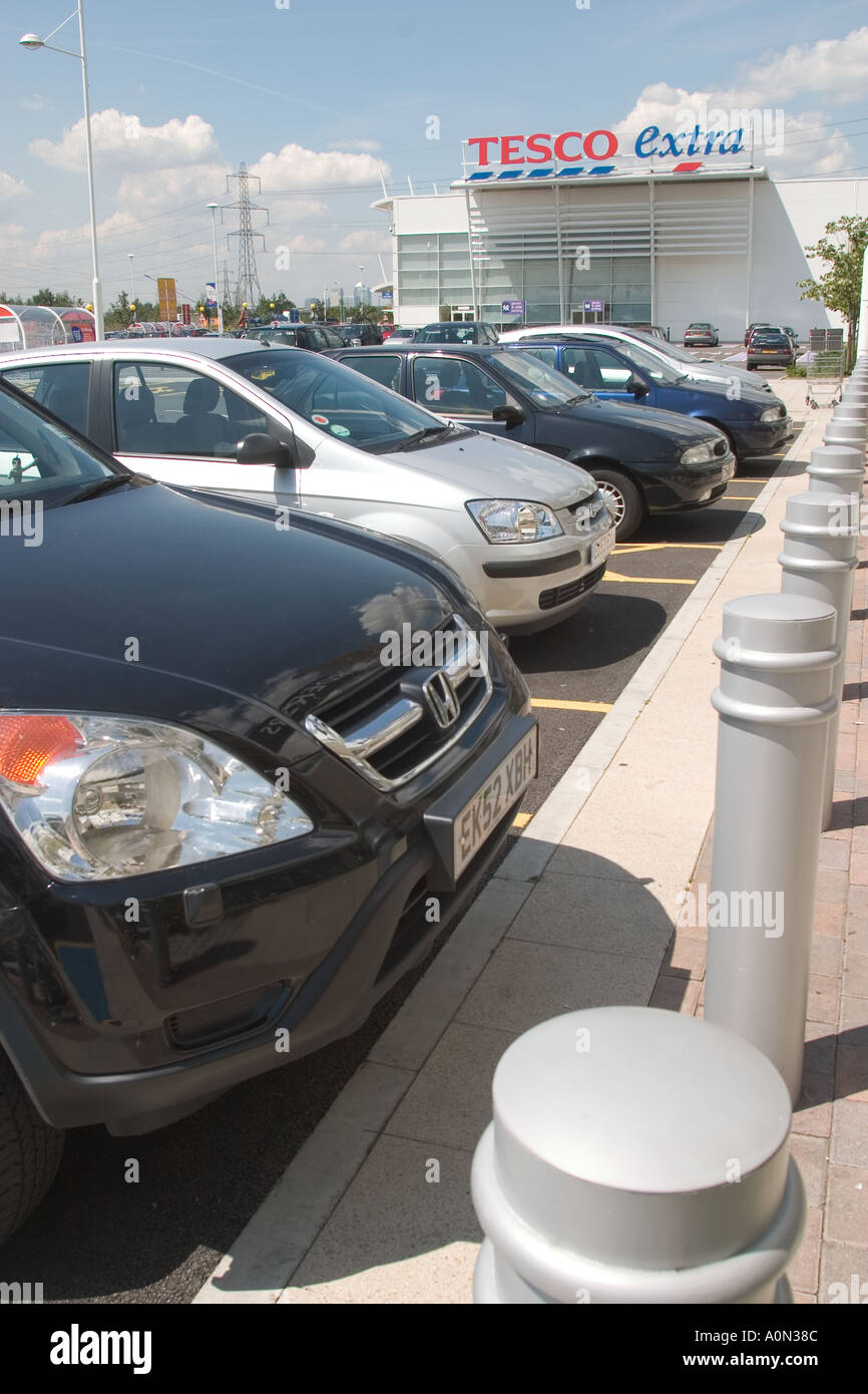 Cars parked near Tesco Metro store at Gallions Reach Retail Shopping ...