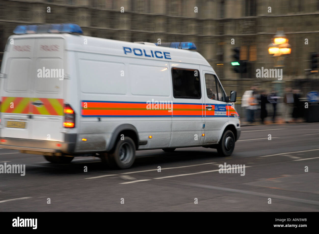 Metropolitan police van racing past the houses of parliament Stock ...