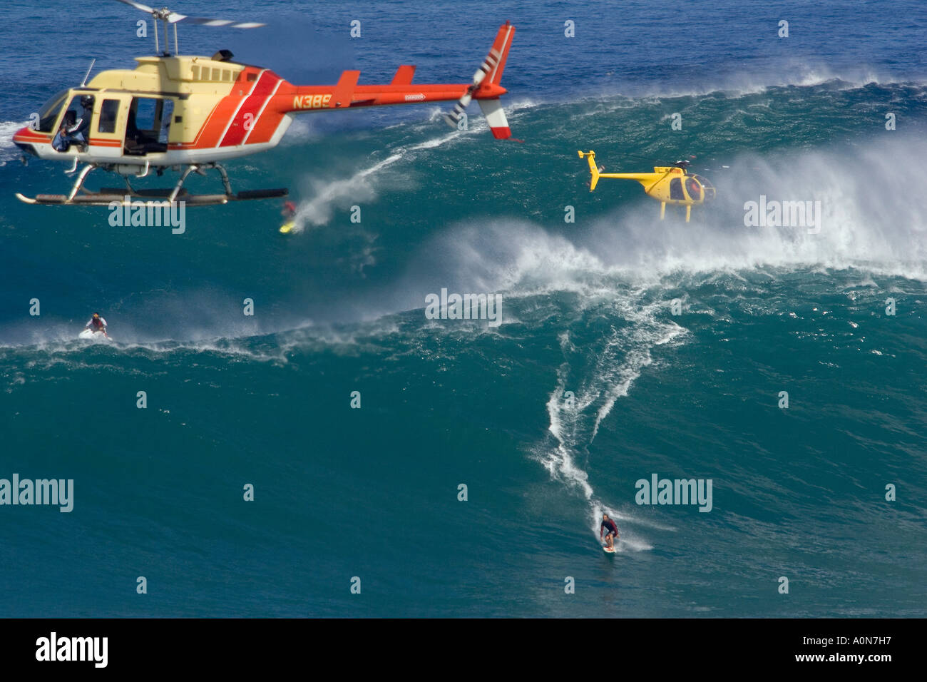 A helicopter filming a tow in surfer at Peahi, (Jaws) off Maui, Hawaii Stock Photo - Alamy