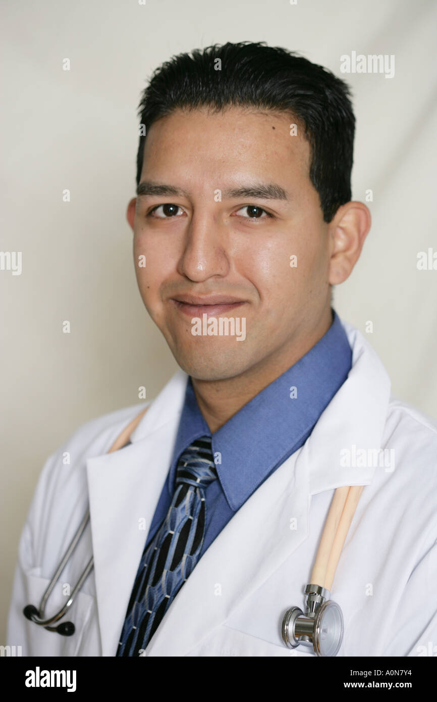 Hispanic / Latino male doctor portrait wearing a white lab coat and ...