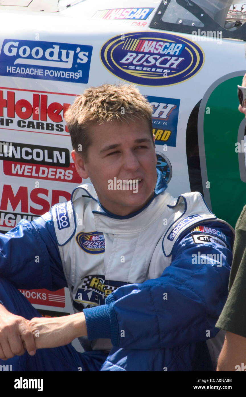 NASCAR driver Stuart Kirby rests by his car in the pit area of the ...