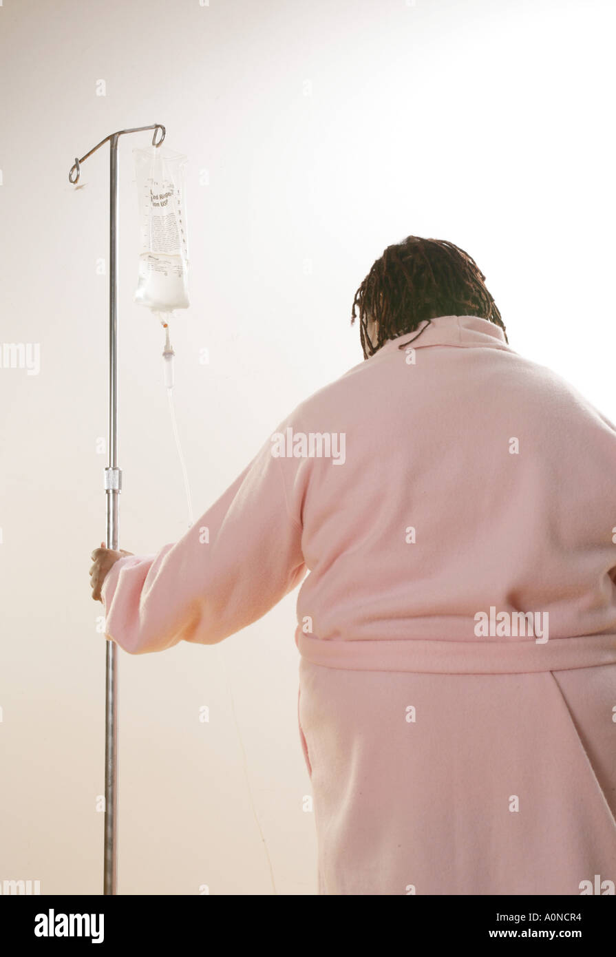 Female patient walks with IV pole Stock Photo - Alamy