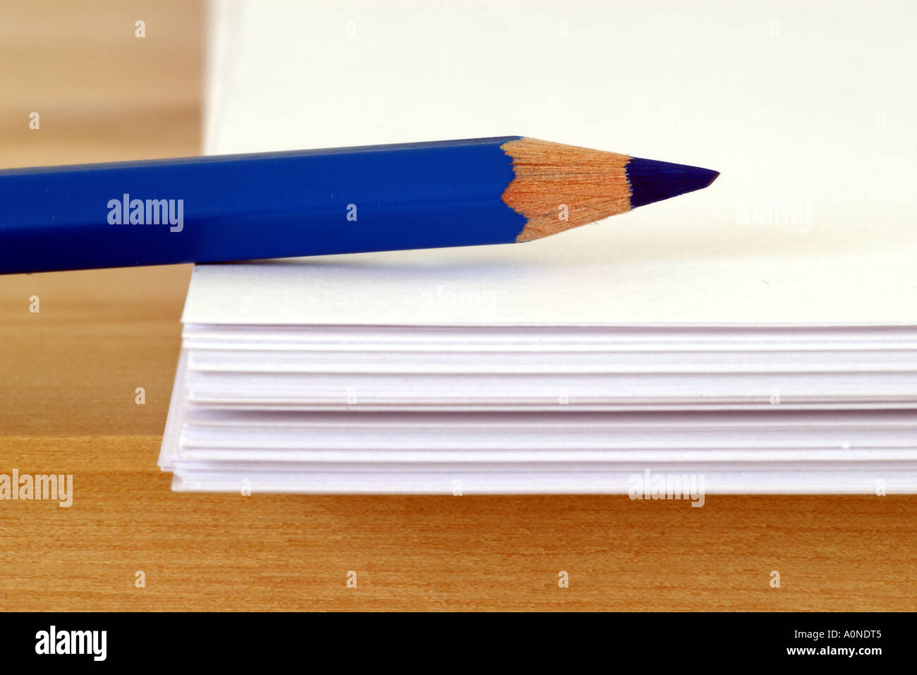 Busy desk: Resting blue pencil and office paper on a desk Stock Photo ...