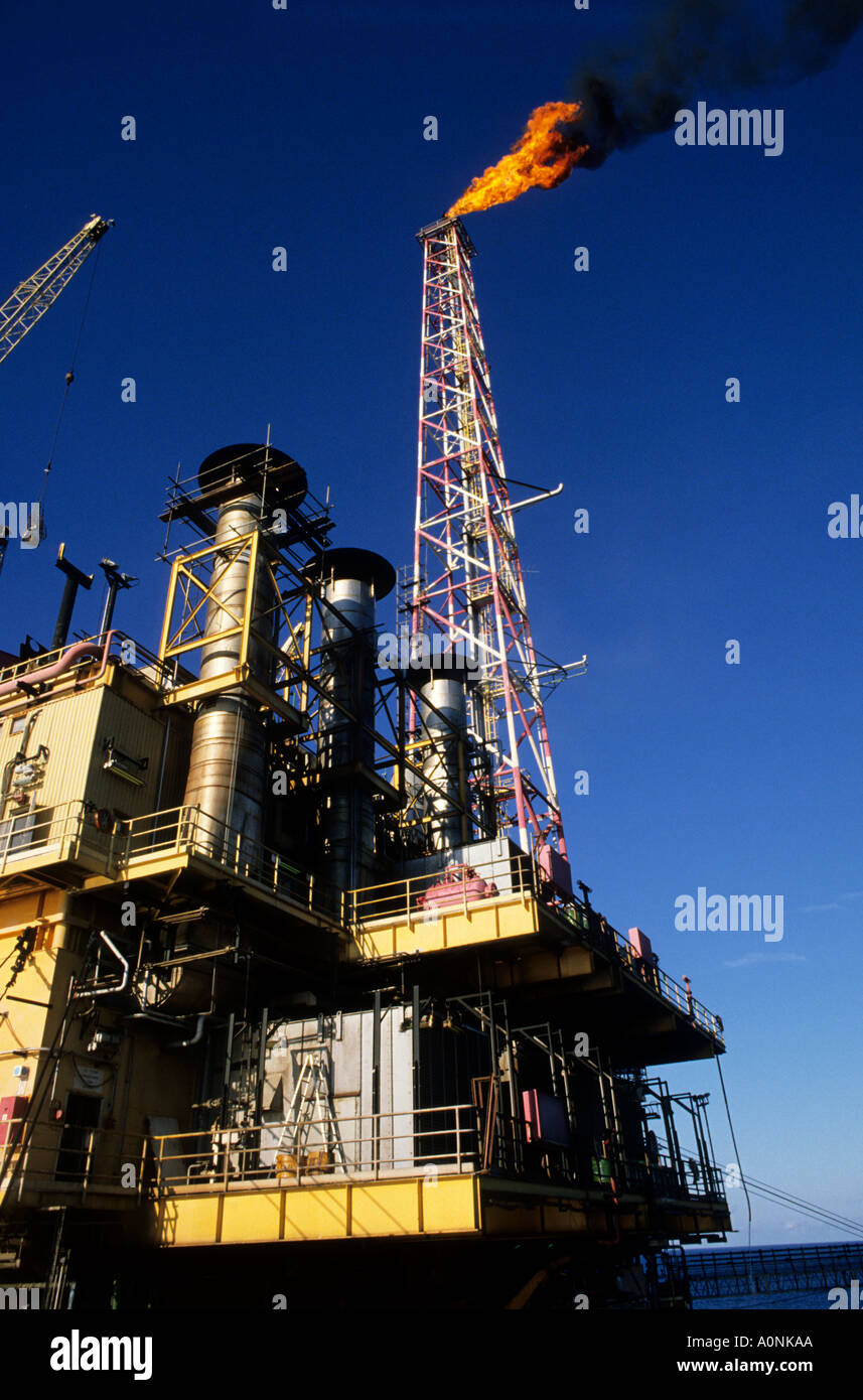 Rio de Janeiro, Brazil. Petrobras oil rig flaring off gas with blue sky ...