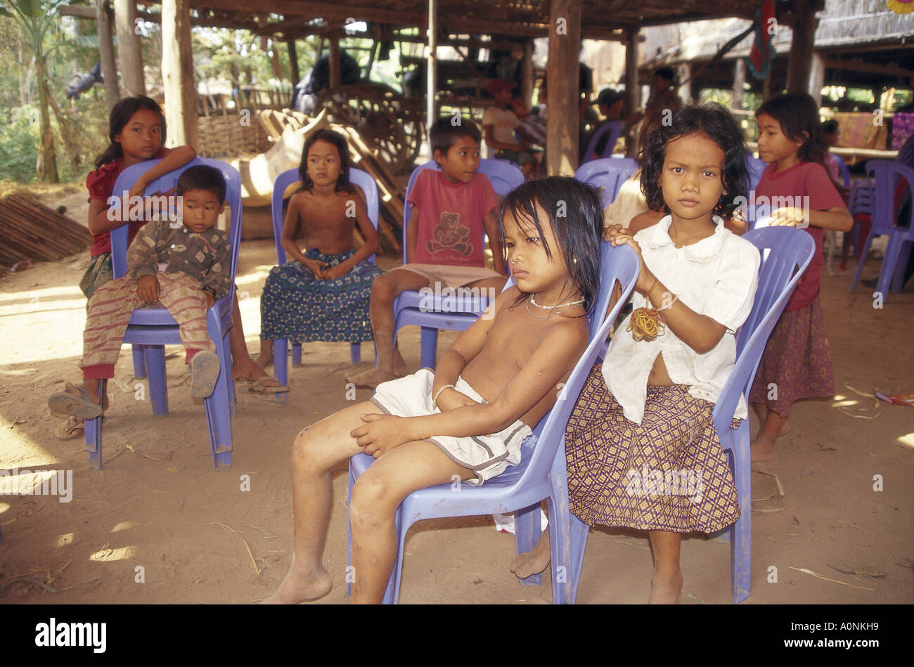 Cambodian village children sitting on blue plastic chairs Cambodia ... Cambodian village children sitting on blue plastic chairs Cambodia ...