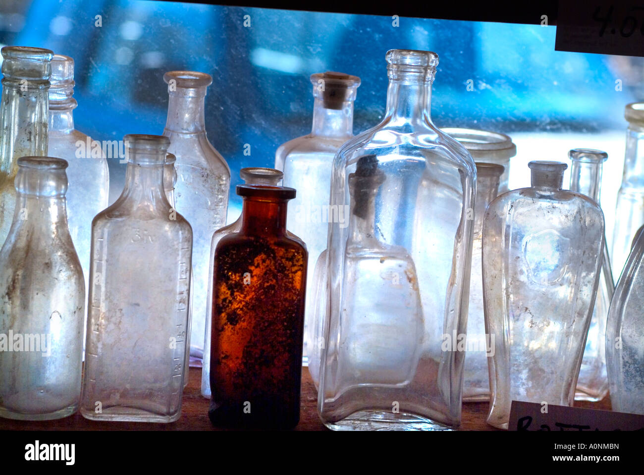 Old restored antique medicine bottles sitting on window sill with ...