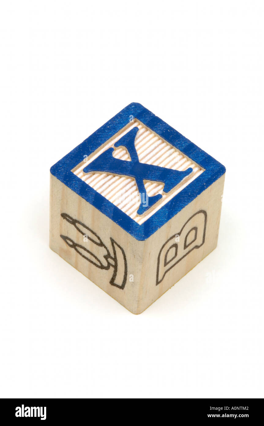 Children wooden learning block showing blue alphabet X on white ...