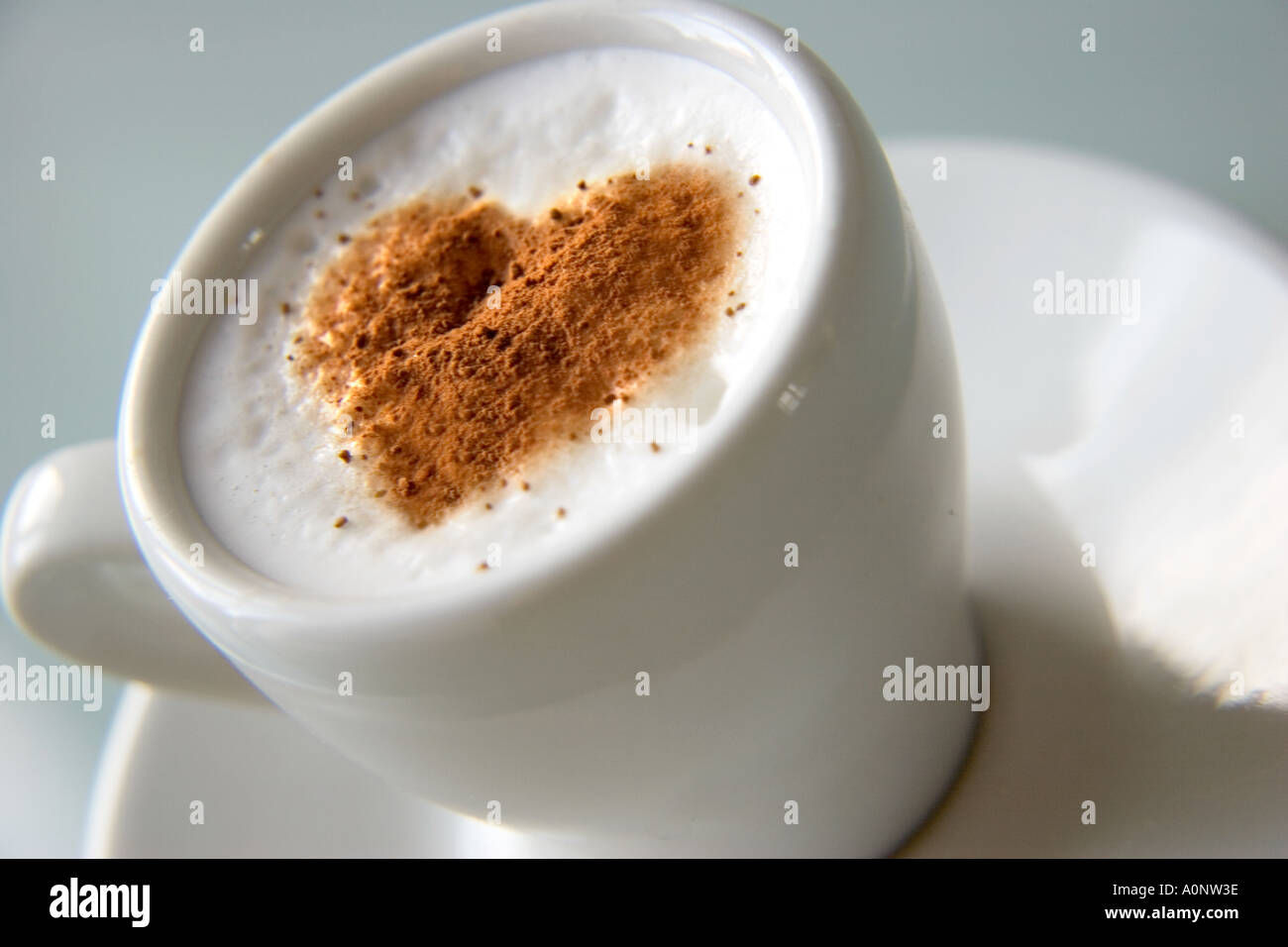 COFFEE FILLED CUP WITH HEART SHAPED COCO POWDER Stock Photo - Alamy
