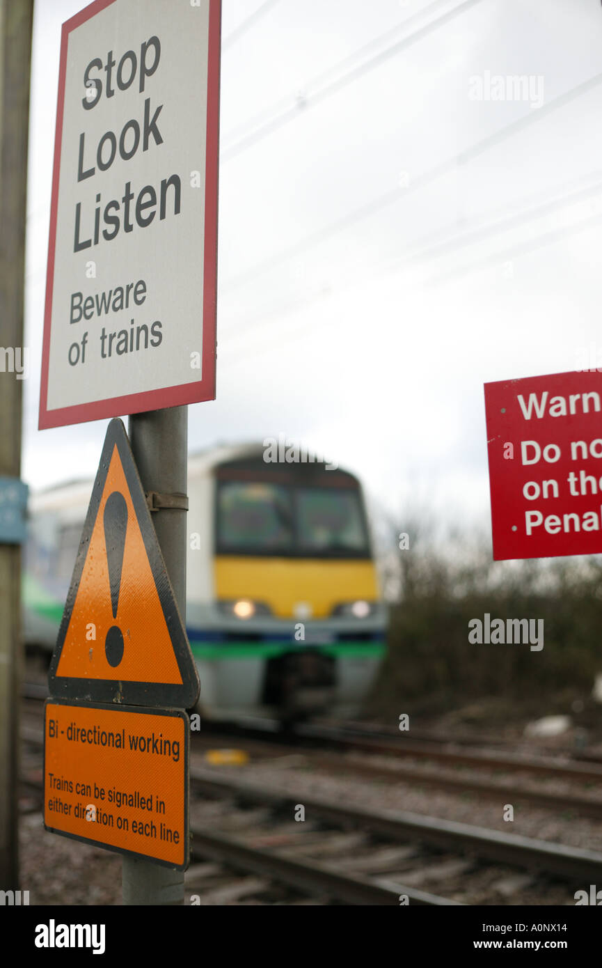 Train passing safety signs at a level crossing Stock Photo - Alamy