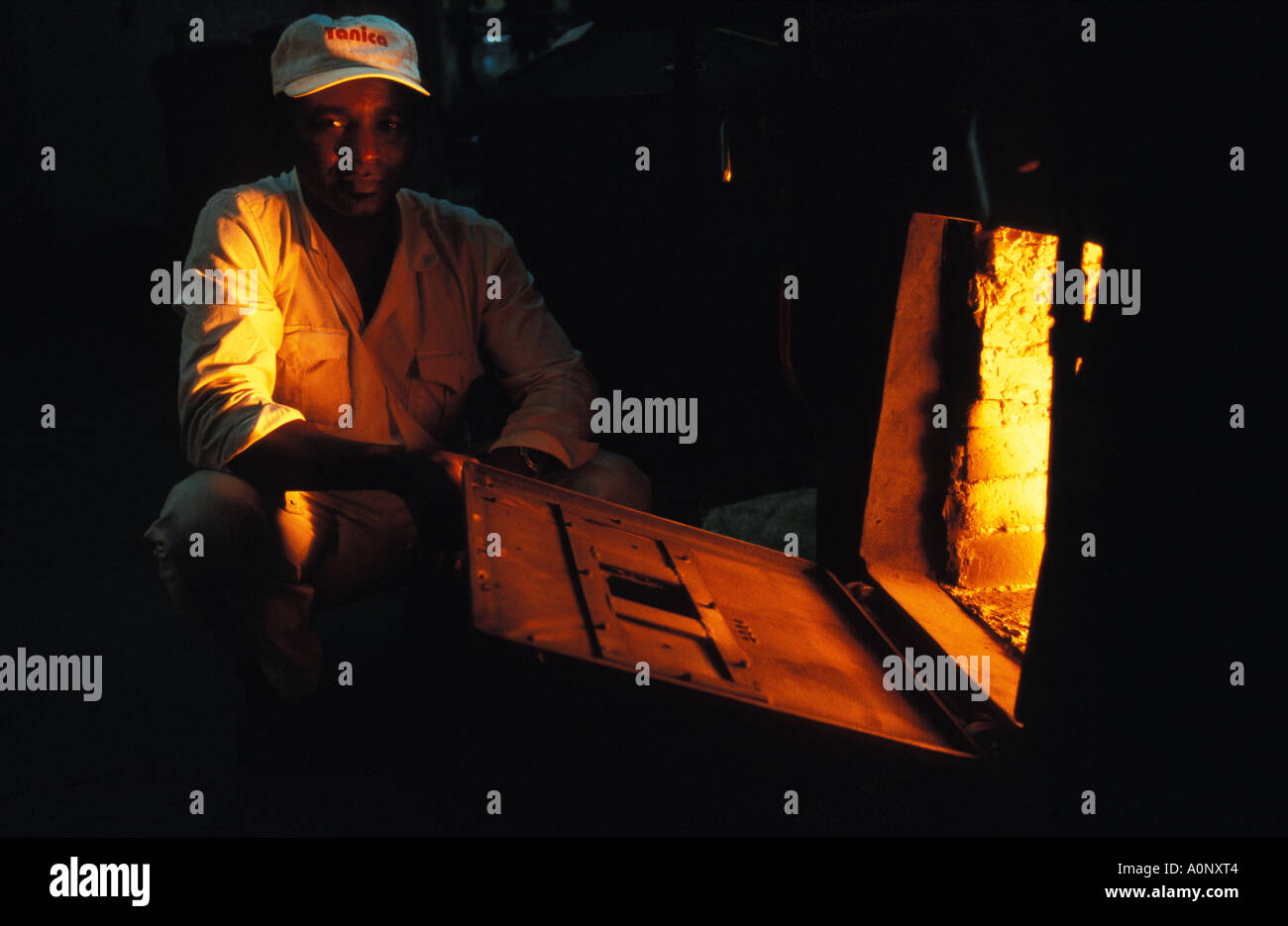 Bukoba worker at the oven that produces the heat to dehydrate coffee ...