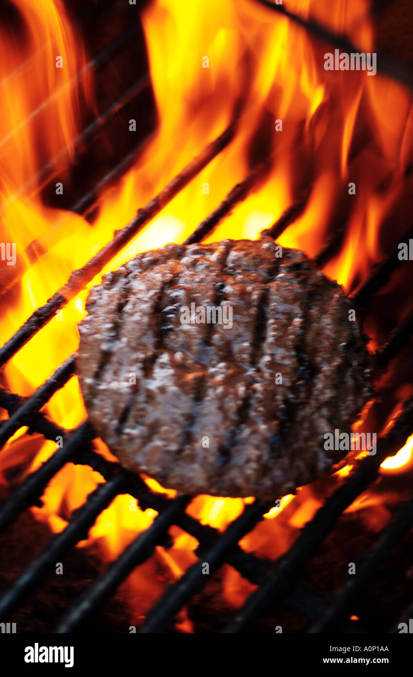 Hamburger patty cooking on open flame barbecue Stock Photo - Alamy