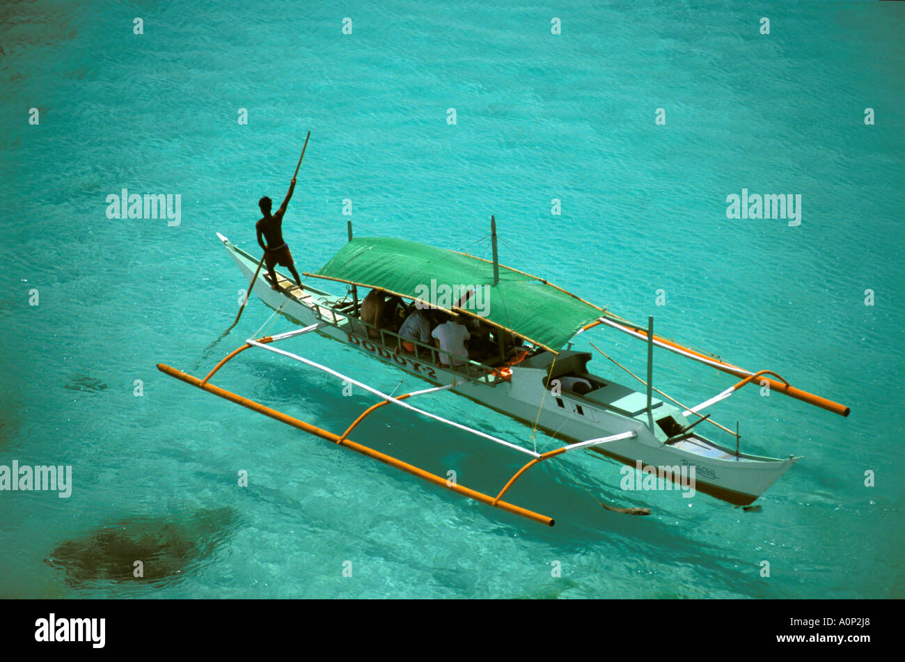 Outrigger boat with passengers Stock Photo - Alamy