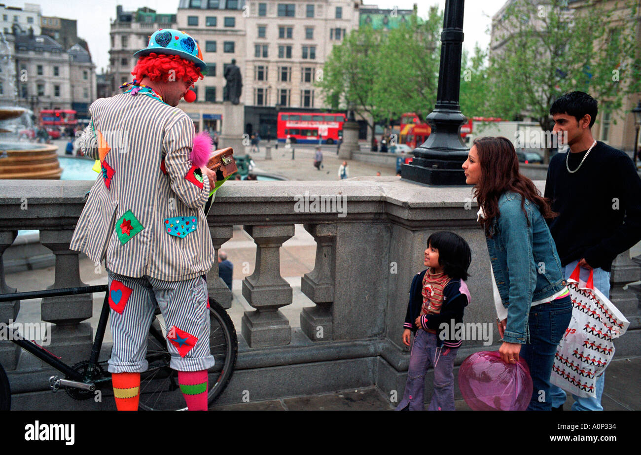 Clown with a family in Trafalgar Square London Stock Photo - Alamy