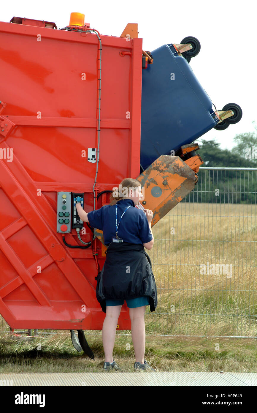 Refuse Collection Lorry with female operative Stock Photo - Alamy