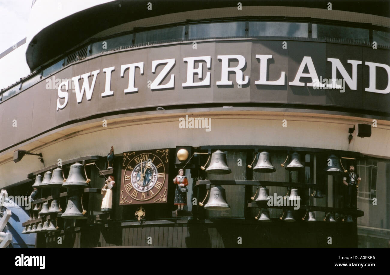 Bells clock and figures in front of the Swiss centre London England UK ...