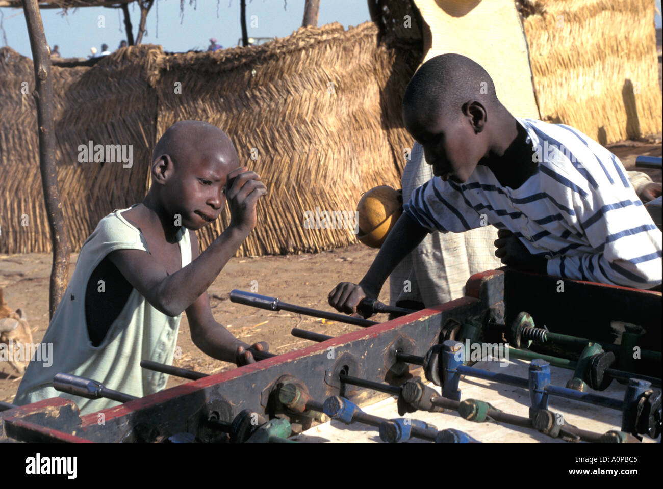 Young Dogon boys play tabletop football in a Bandiagara Escarpment ...