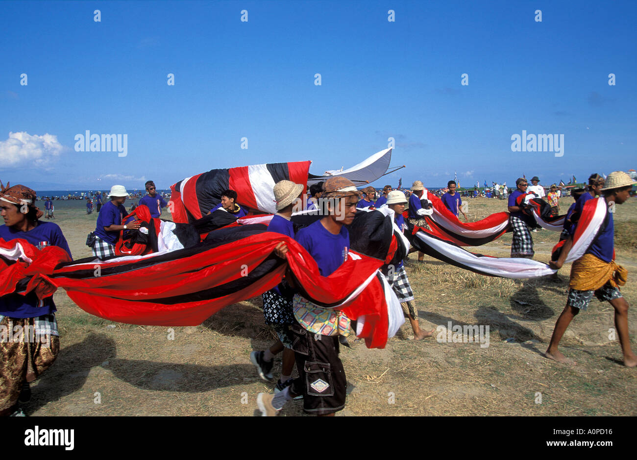 Indonesia Bali Team members carrying the long tail of the dragon tail ...
