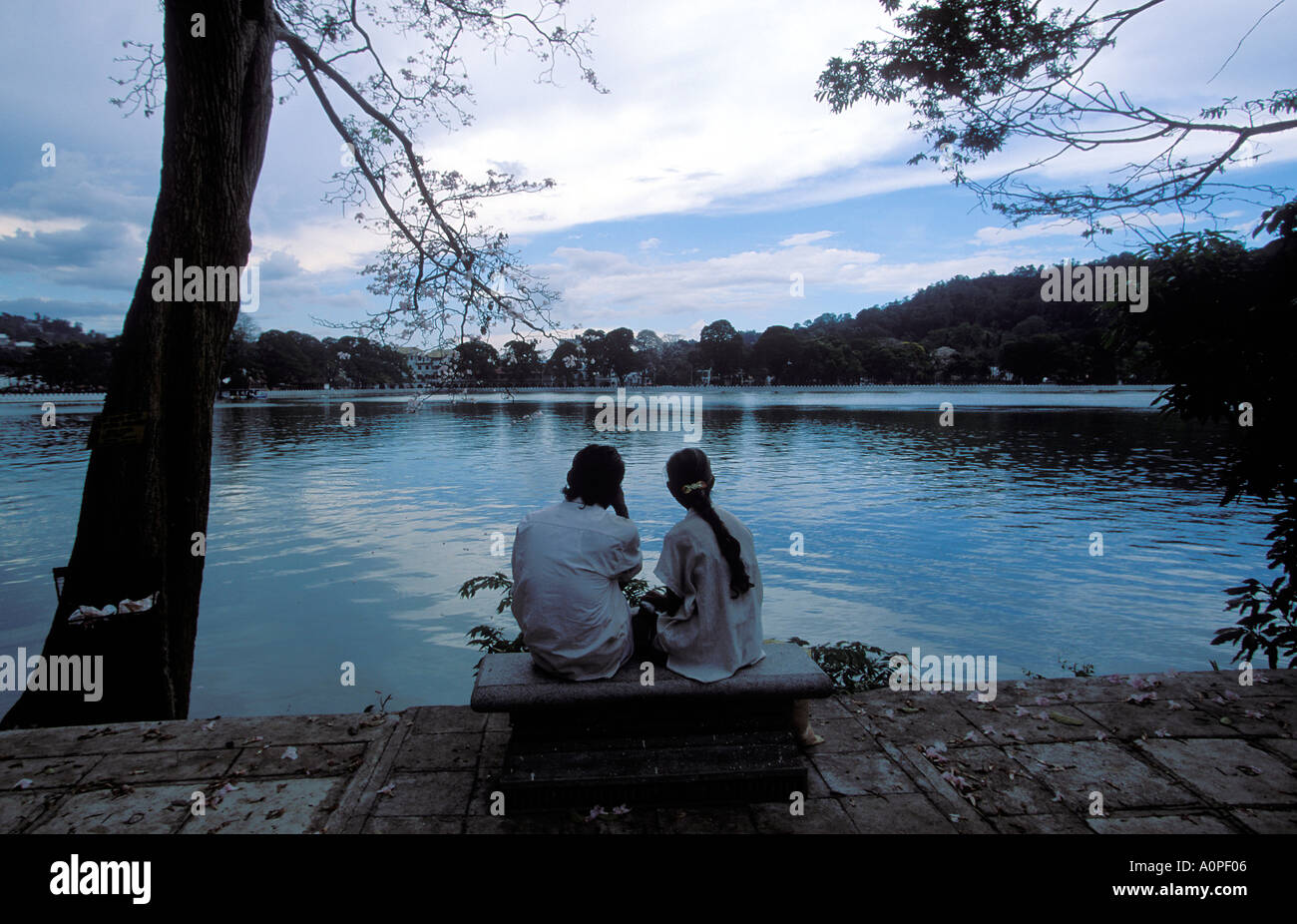 couple sitting on a bench by Kandy Lake Kandy Sri Lanka Stock Photo - Alamy