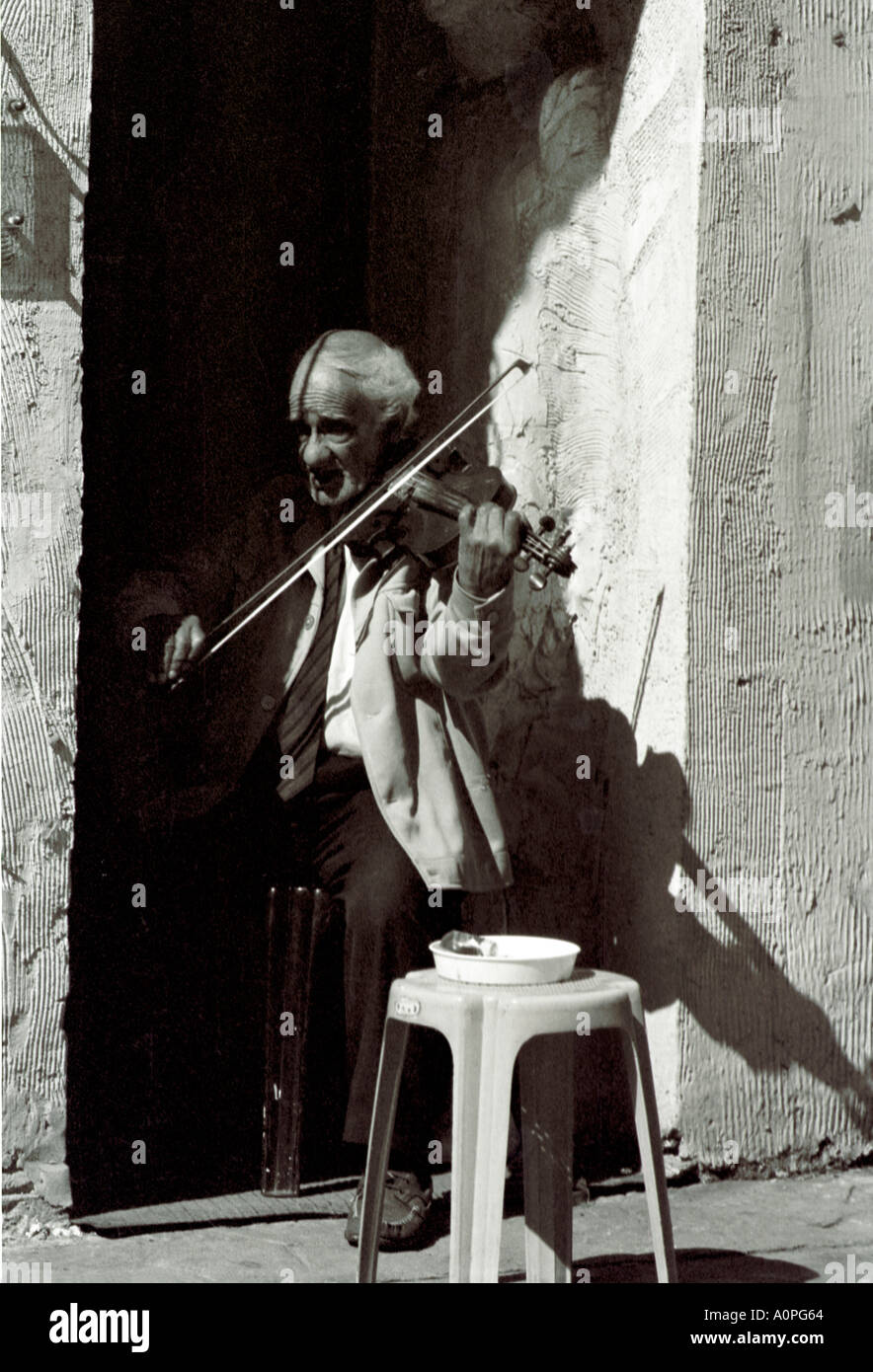 Violinist Playing In The Shadows Of A Doorway Stock Photo - Alamy