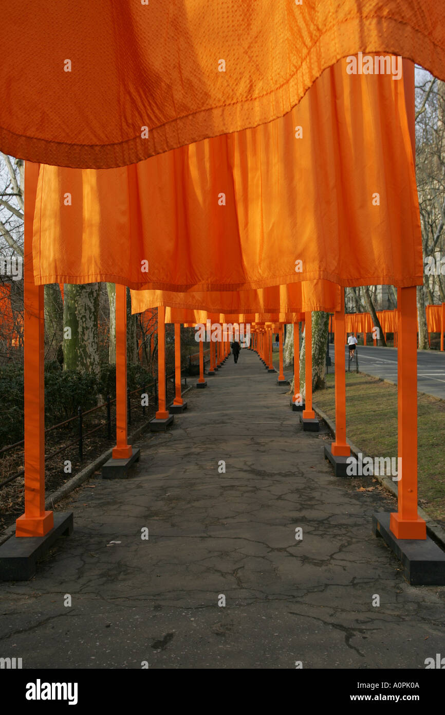 A tunnel of orange recycled material plastic tori gates part of the ...