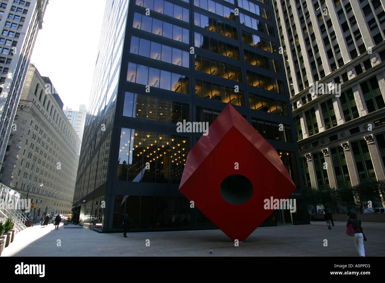 Large cubic sculpture stands outside a modern skyscraper building ...