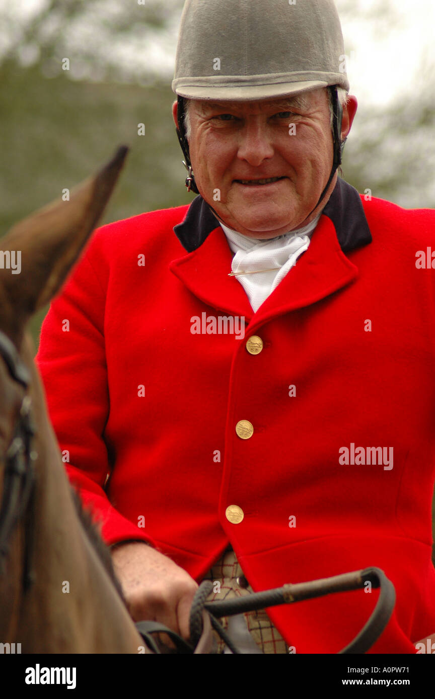Huntsman smiling sat on a horse Stock Photo - Alamy