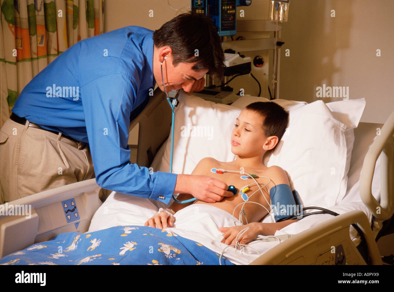 Hospital. Paediatrics. Paediatrician. Intensive care doctor at bedside ...