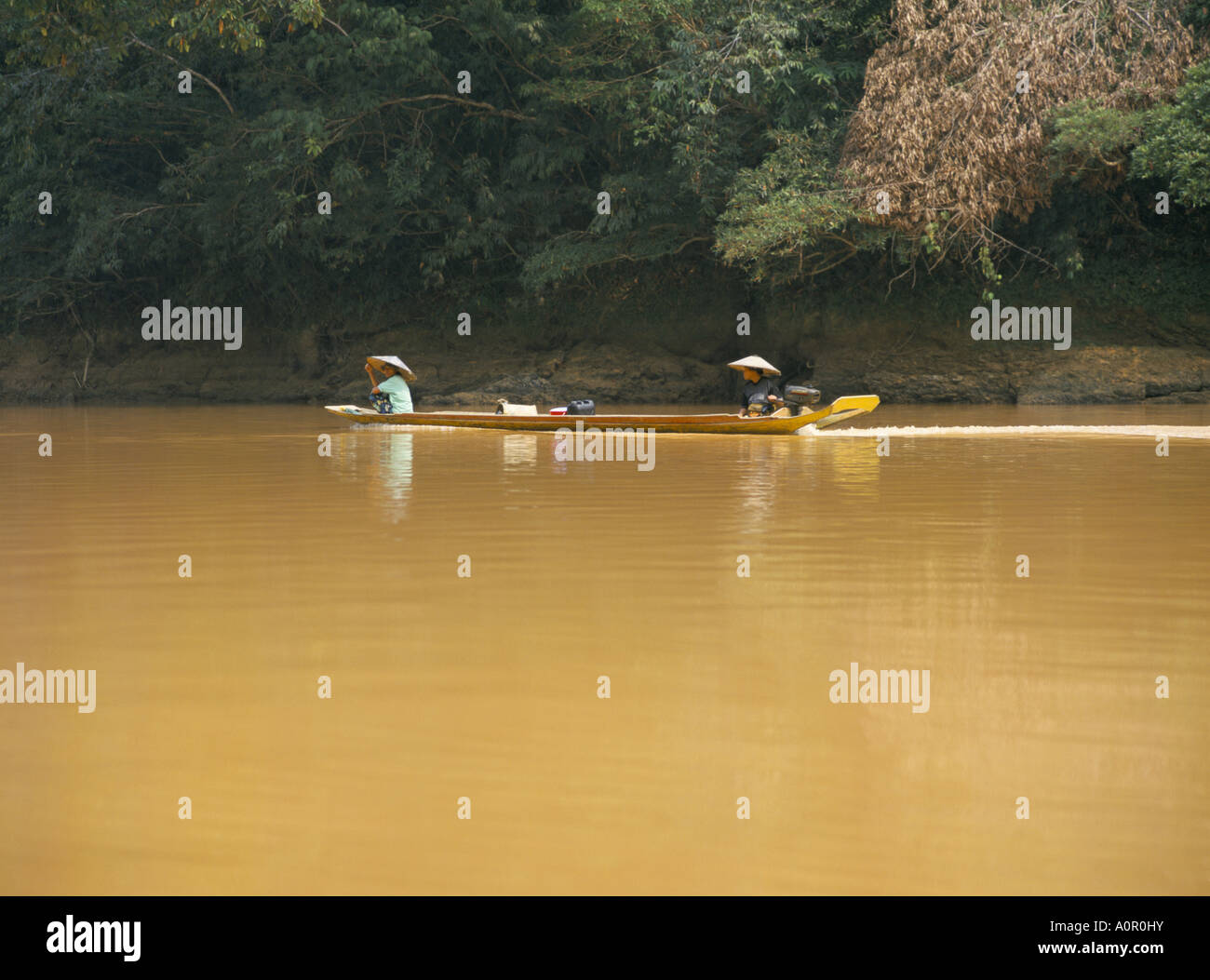 Travel by outboard powered local longboat Katibas River Sarawak island ...