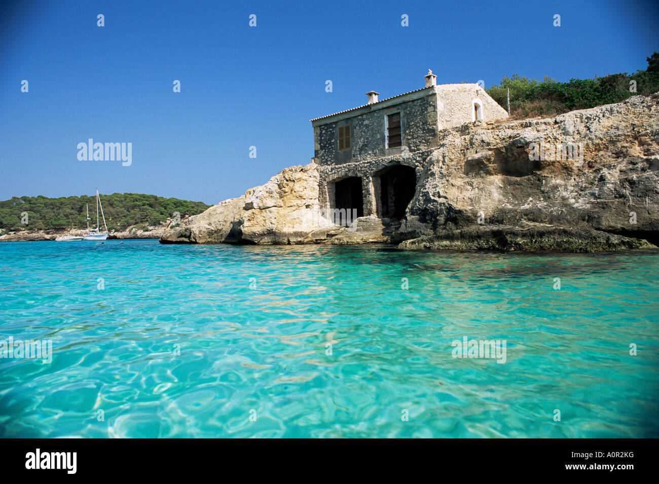 Stone dwelling overlooking bay Cala Mondrago Majorca Balearic Islands ...