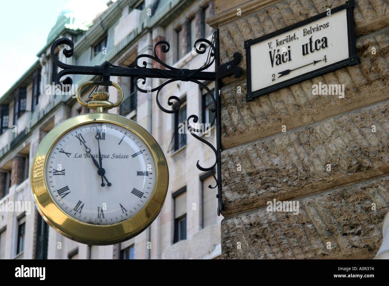 Clock in the shape of a pocketwatch on a shop in Budapest Hungary Stock ...