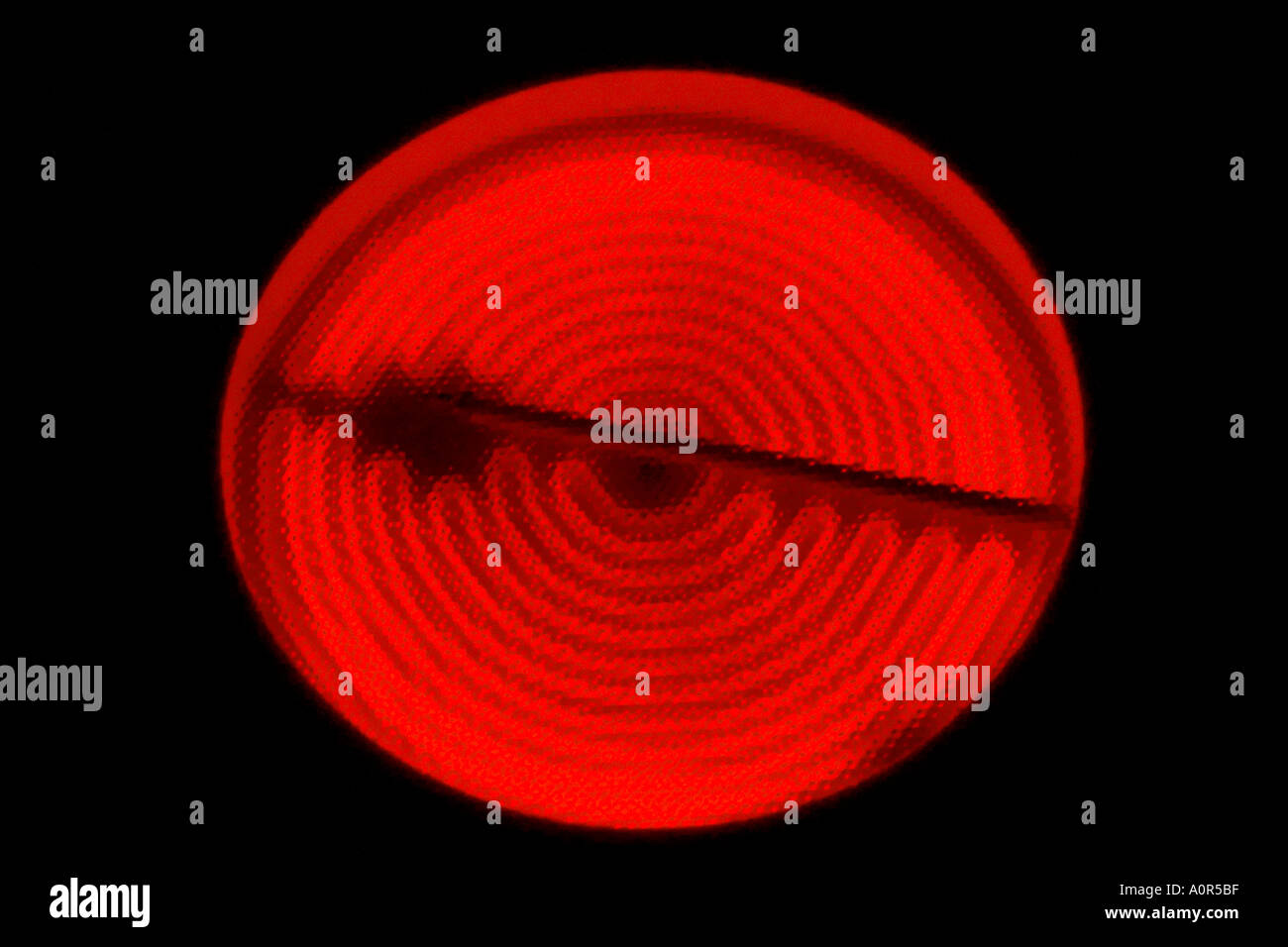 Electric vitroceramic burner glowing red-hot Stock Photo - Alamy